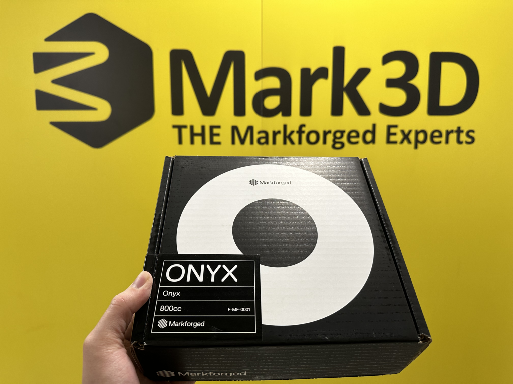 A spool of Markforged Onyx 3D Printing Filament being held in from of the Mark3D UK The ...
